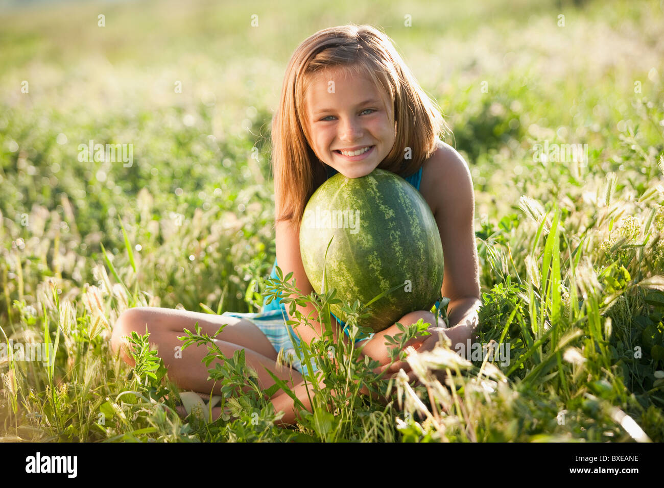 Young girl holding a watermelon Stock Photo - Alamy