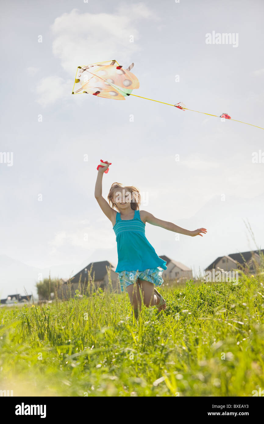 Young girl flying a kite Stock Photo - Alamy