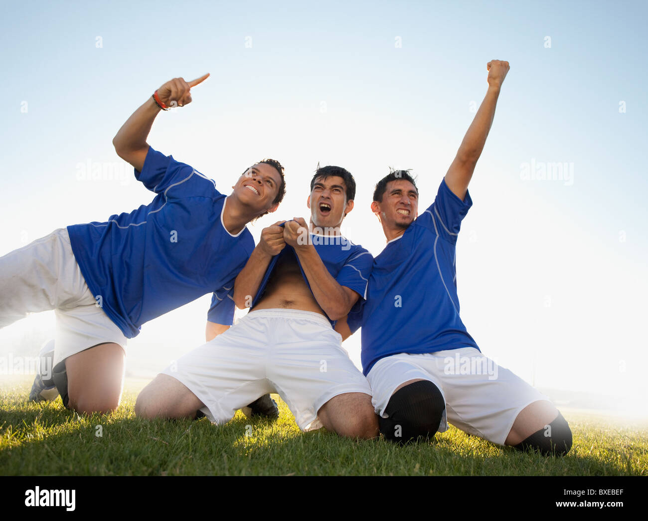 Three happy soccer players Stock Photo - Alamy