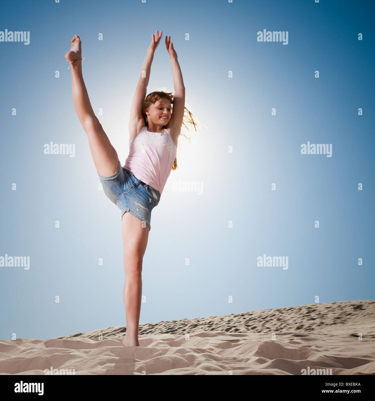 Woman dancing in sand Stock Photo - Alamy