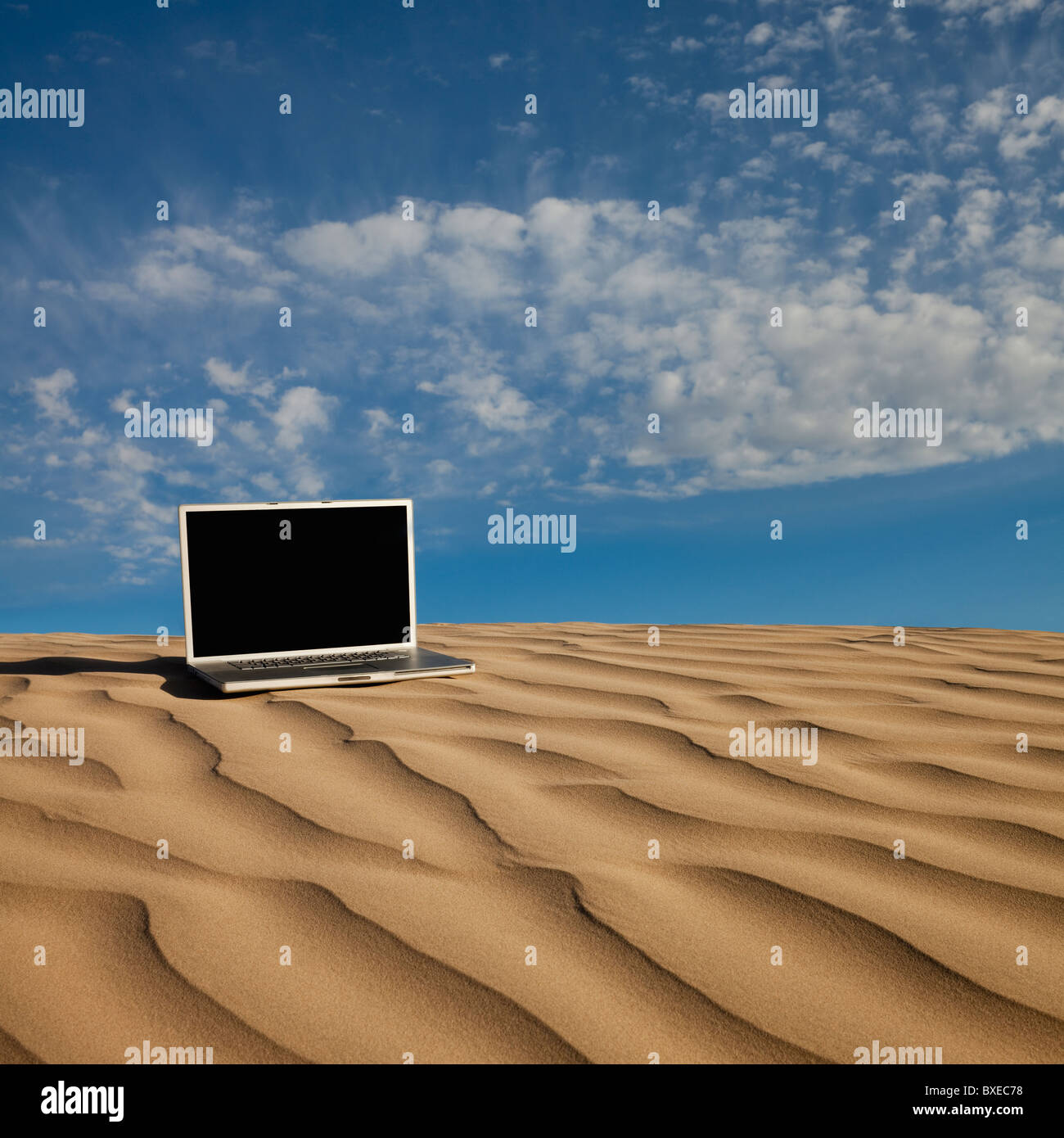 Laptop computer on desert sand Stock Photo - Alamy