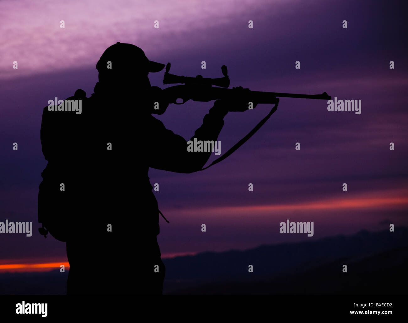 Hunter looking through scope of rifle Stock Photo - Alamy