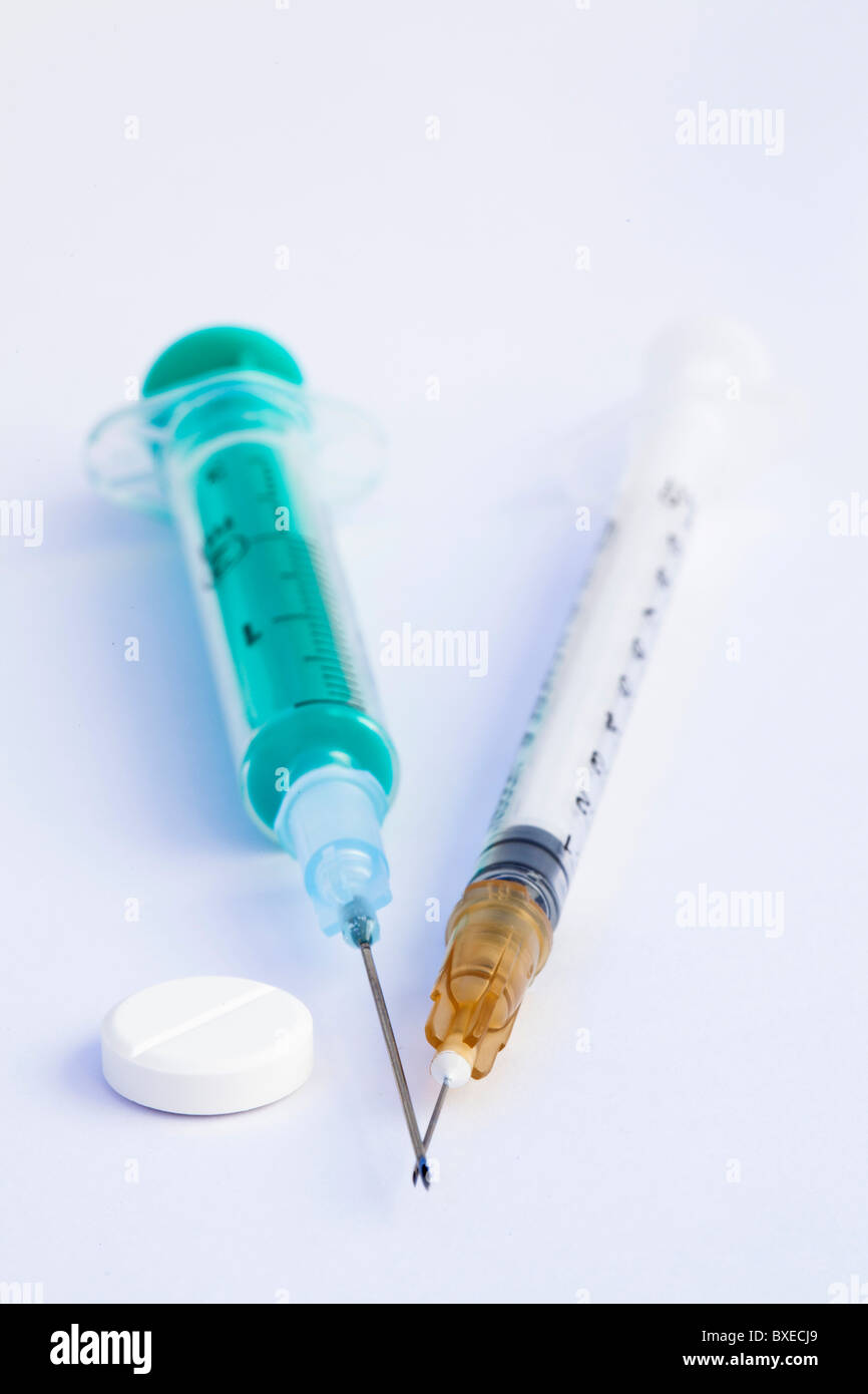 two syringe with tablet on white background Stock Photo - Alamy