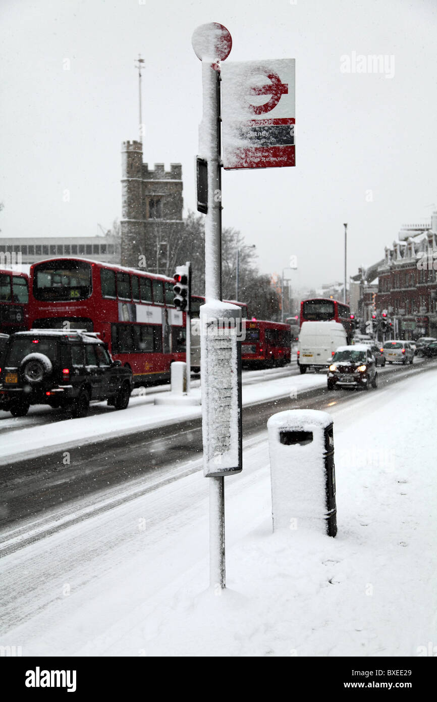 A bus stop covered in snow. Putney Bridge. London Stock Photo - Alamy