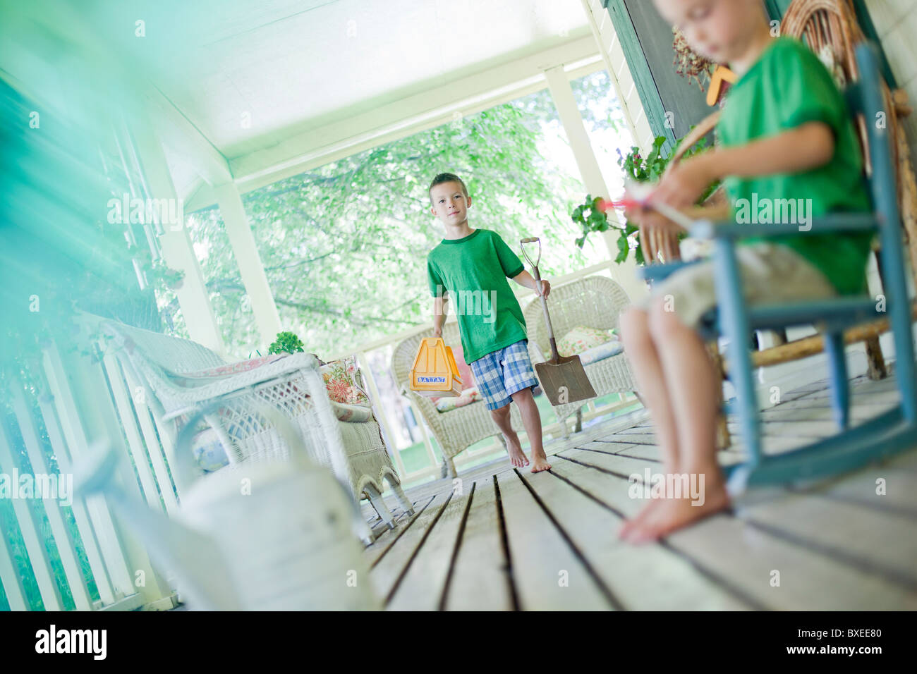 Two young boys on porch Stock Photo - Alamy