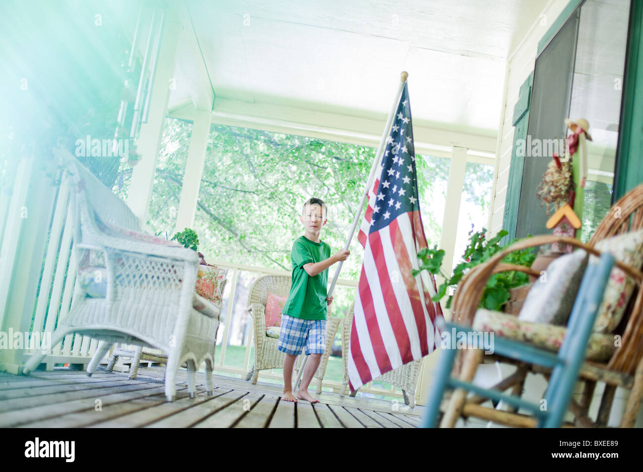 Young boy carrying American flag Stock Photo - Alamy