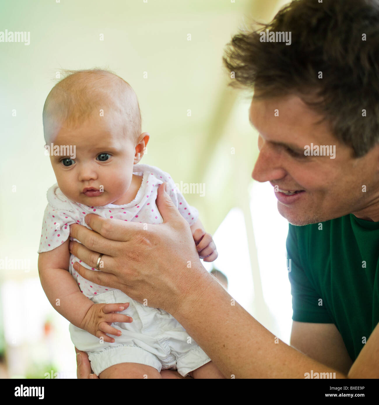 Father holding his baby daughter Stock Photo - Alamy