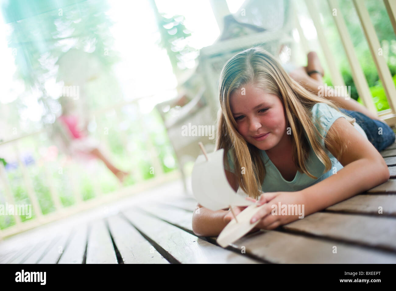 Young girl playing with toy boat Stock Photo - Alamy