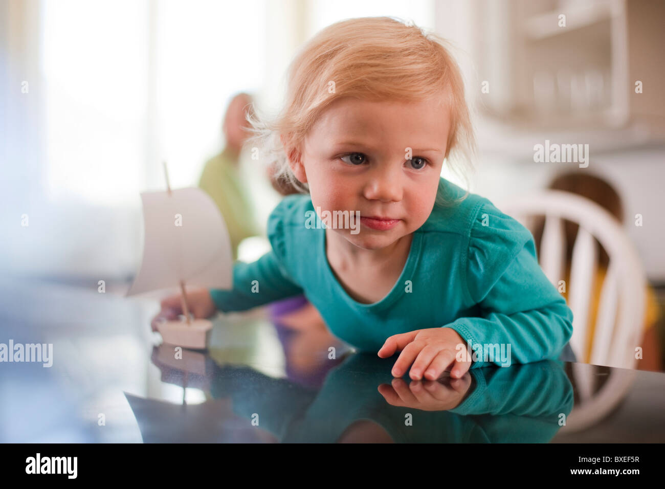Young girl playing with toy boat Stock Photo - Alamy