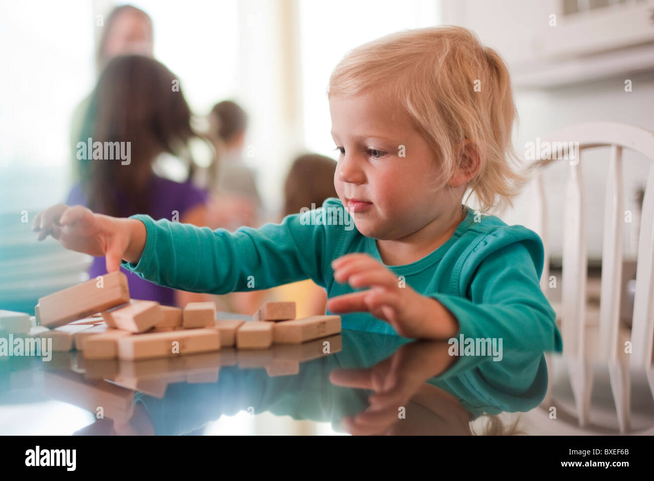Children playing wooden building blocks hi-res stock photography and ...