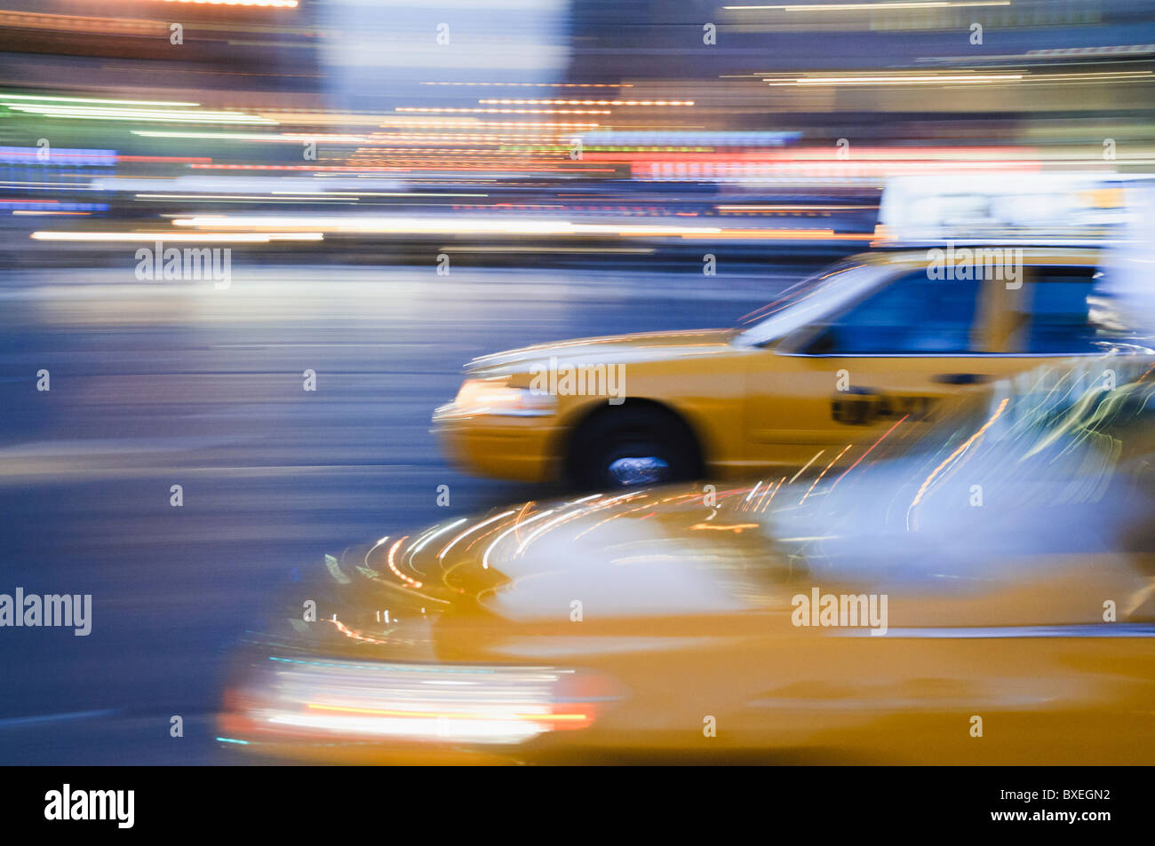 Taxi cabs driving at night Stock Photo - Alamy
