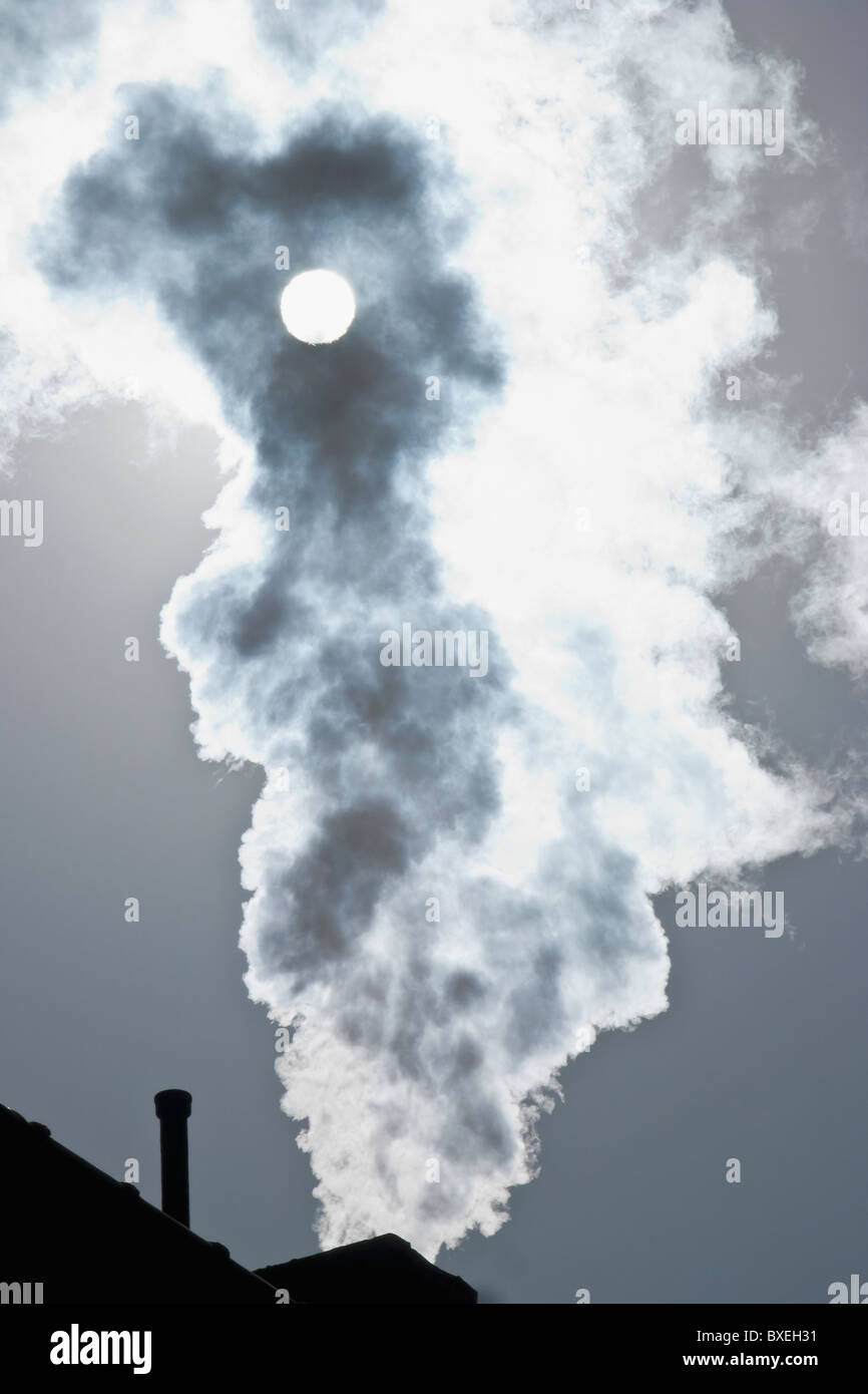 Smoke coming out of factory chimney Stock Photo - Alamy
