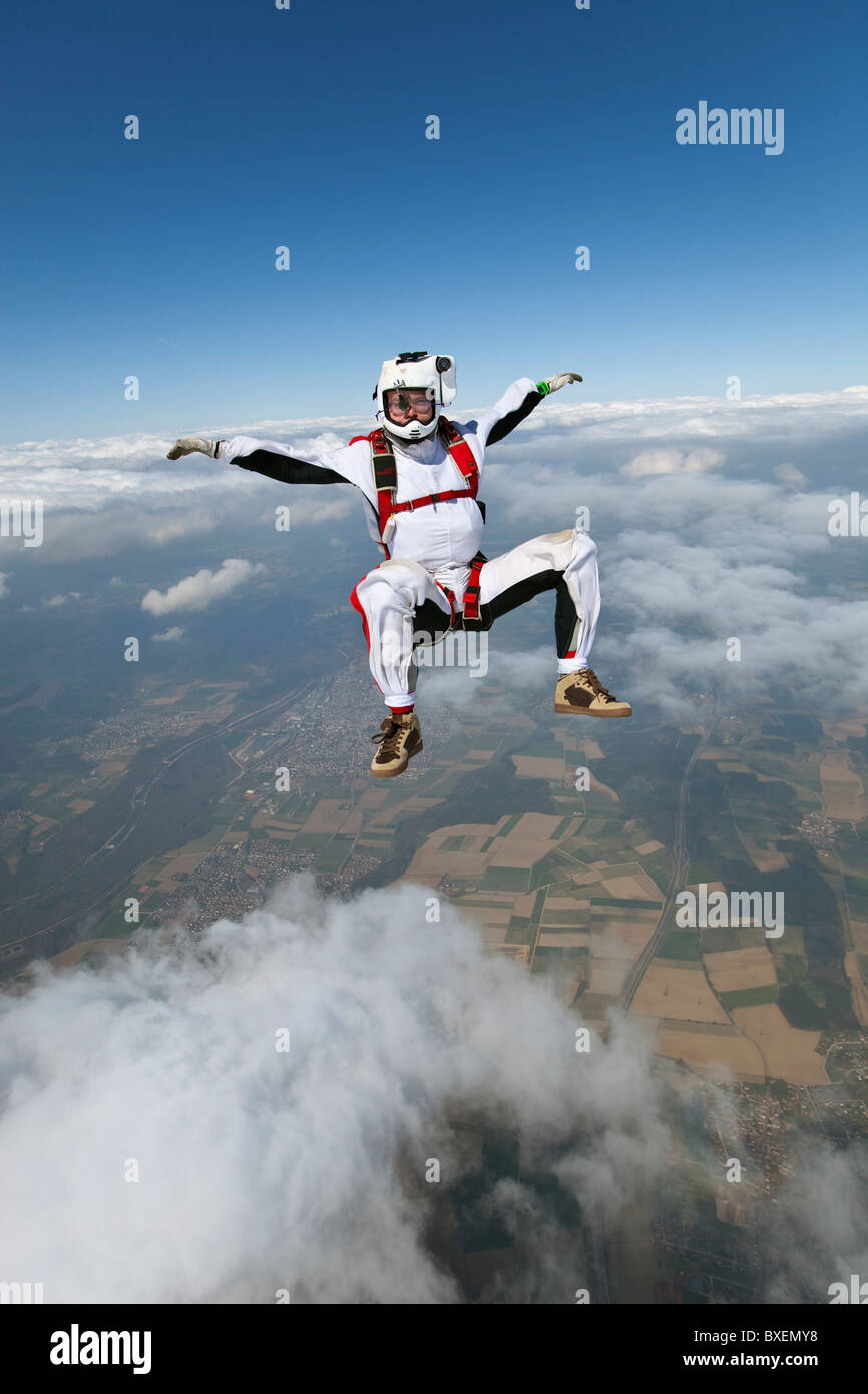 Man with camera on his helmet is filming skydiver in freefall over ...