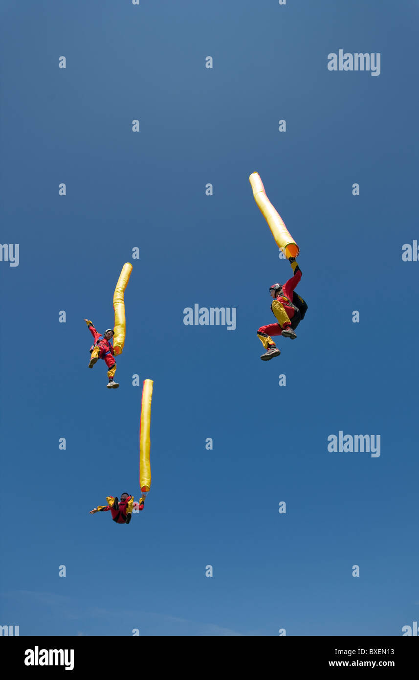 Freefly skydive team is training with air tubes formation on the blue ...