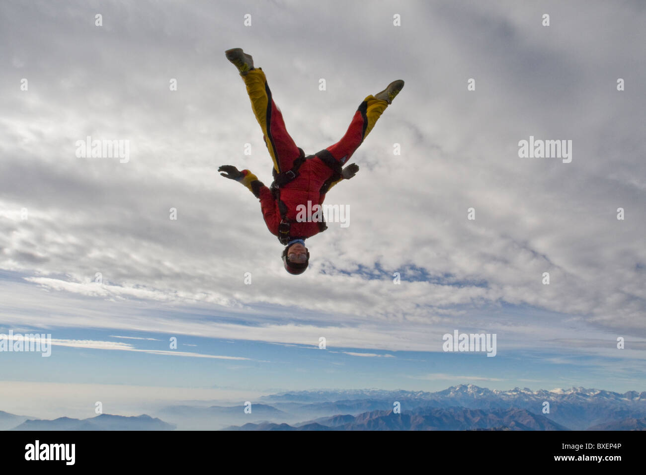 Skydiver girl is practise the head down position and flying free over ...