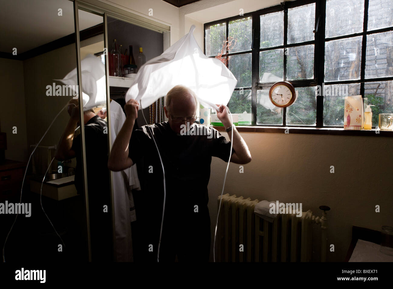 Priest puts on his Amice before morning Mass in Sacristy (Vestry) at St ...