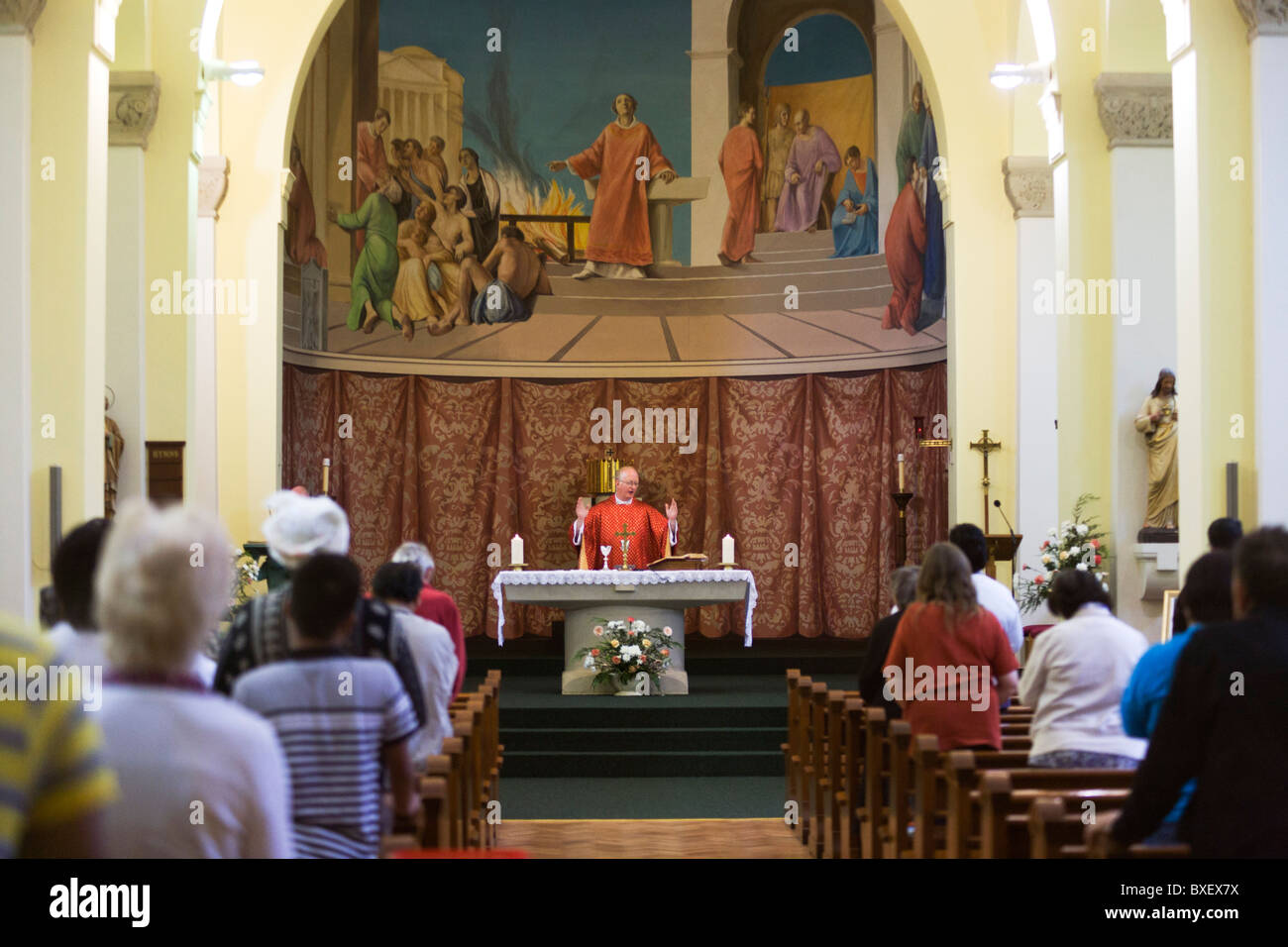 Priest gives blessings during daily Mass at St. Lawrence's Catholic ...