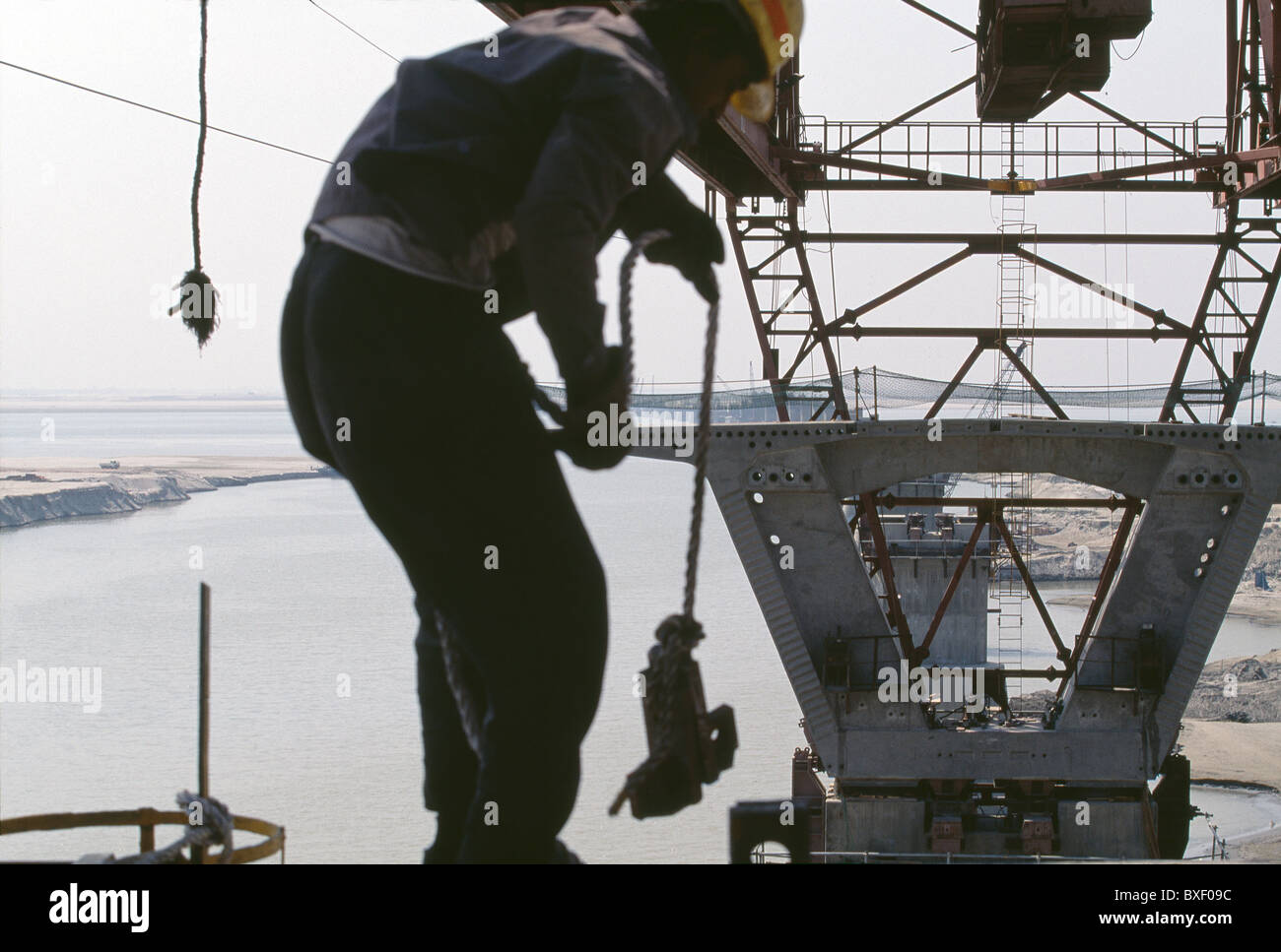 A laborer works with construction material on the 4.8 km Jamuna Bridge ...