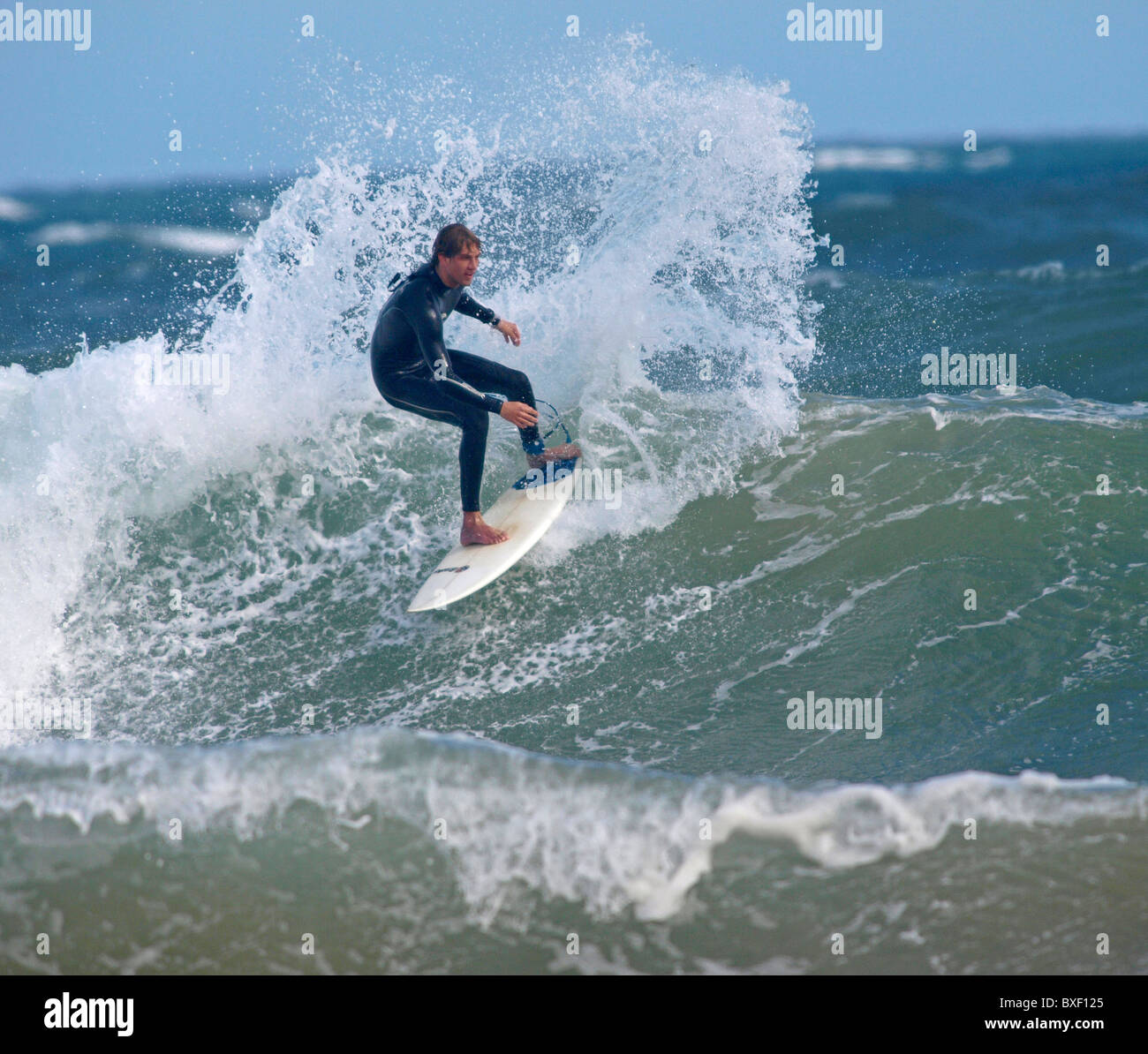 LONE MALE SURFER RIDING WAVES AND DOING TRICKS, TORQUAY, VICTORIA ...