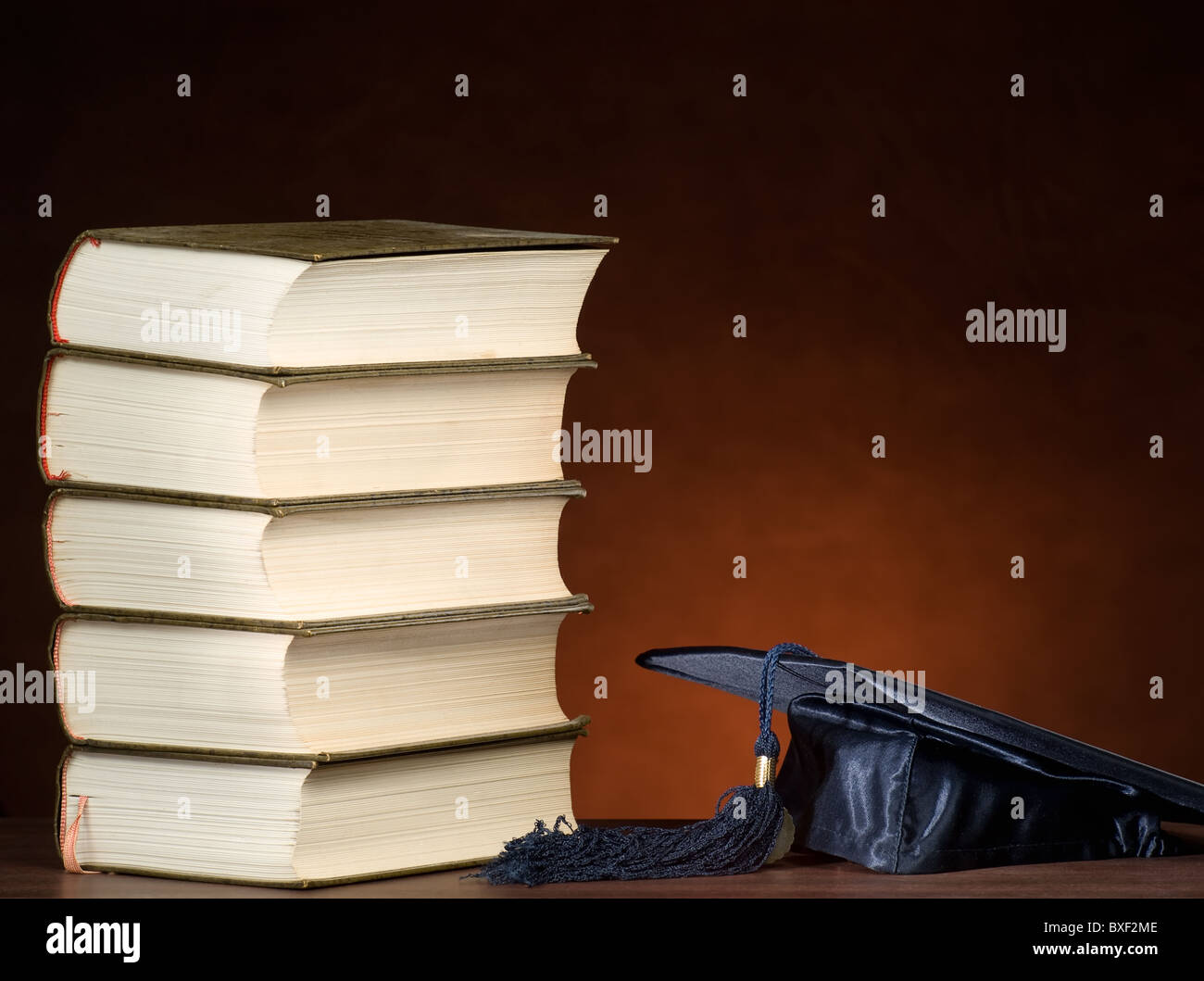 Stack of books and graduation cap, for various education,graduation or ...