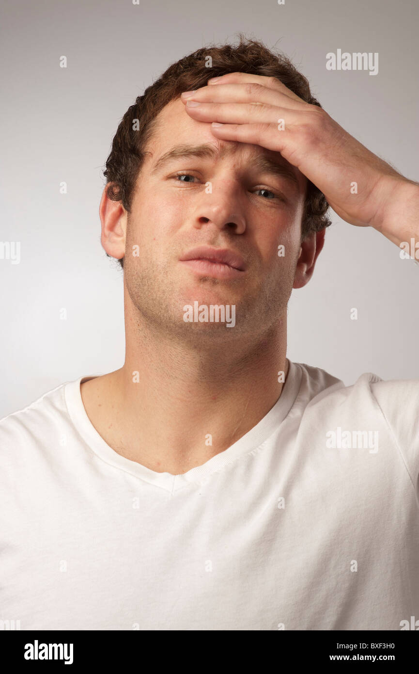 white caucasian male man suffering with a headache sore head hangover ...