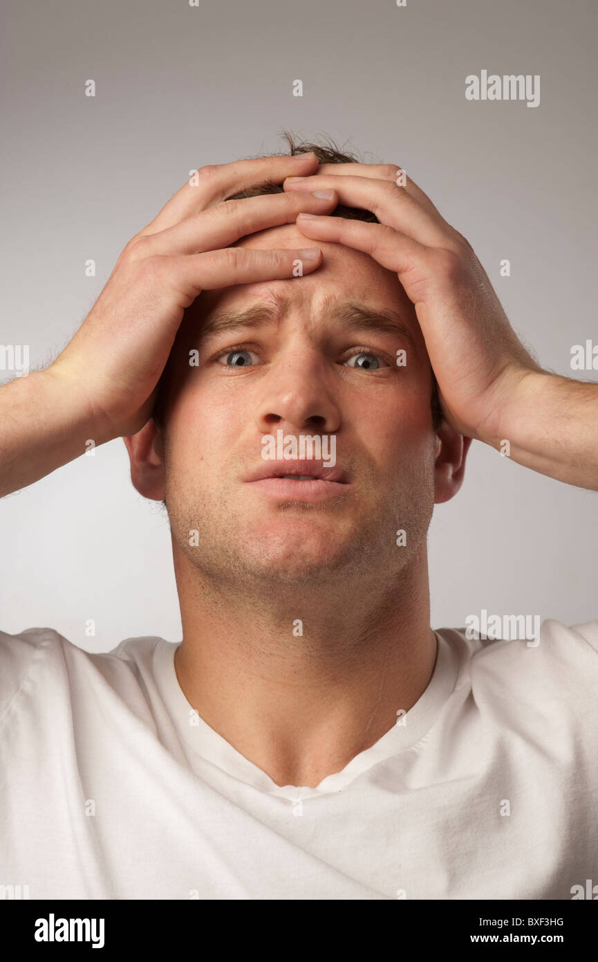 white caucasian male man suffering with a headache sore head hangover ...