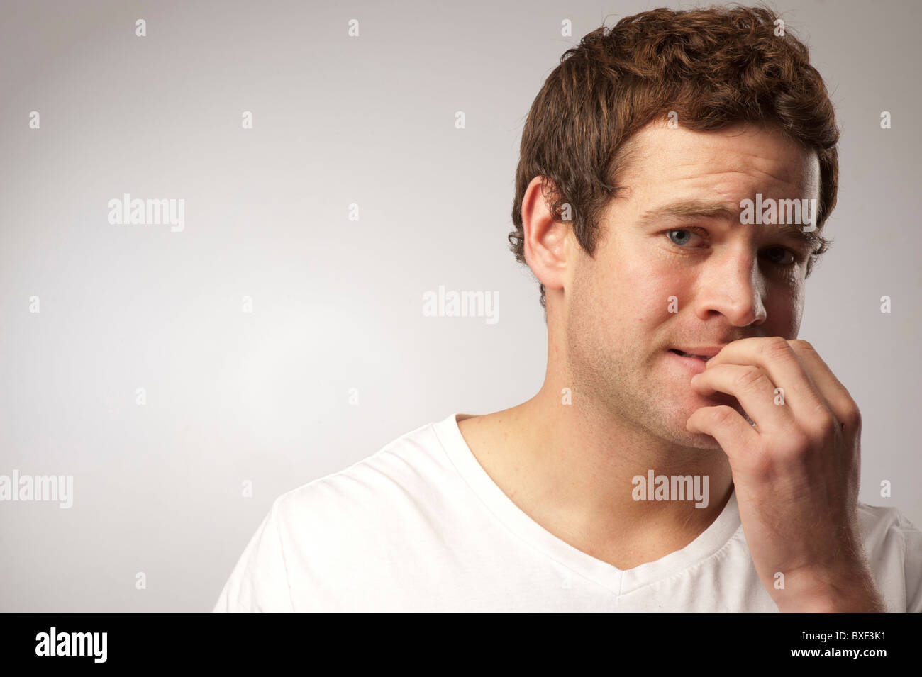 anxious nervous white caucasian male man biting his nails Stock Photo ... anxious nervous white caucasian male man biting his nails Stock Photo ...