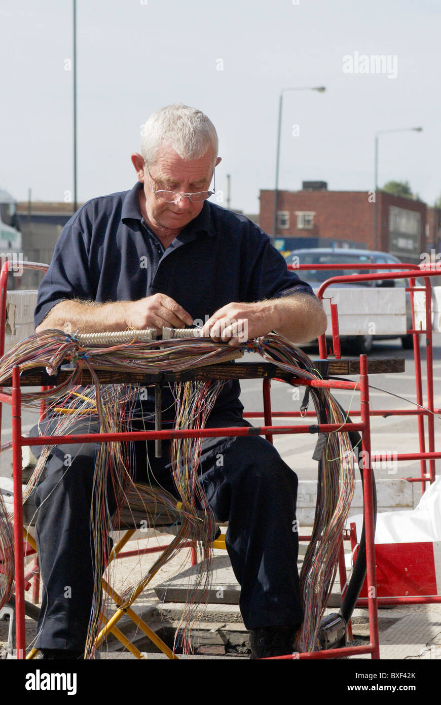 Engineer repairing telephone wires Stratford East London UK Stock Photo ...