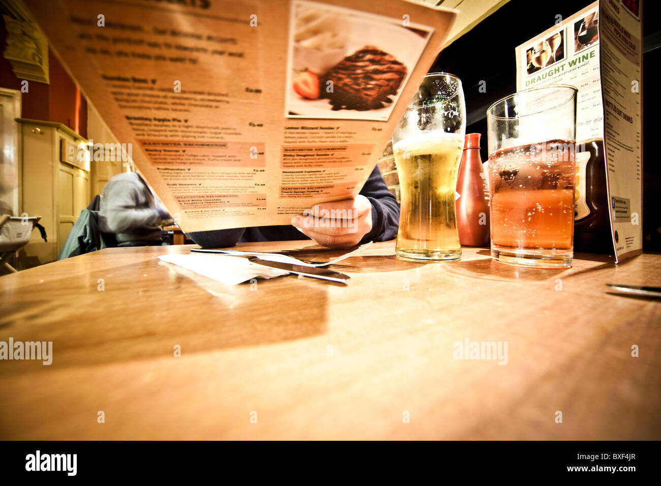 man looking at menu in a pub Stock Photo - Alamy