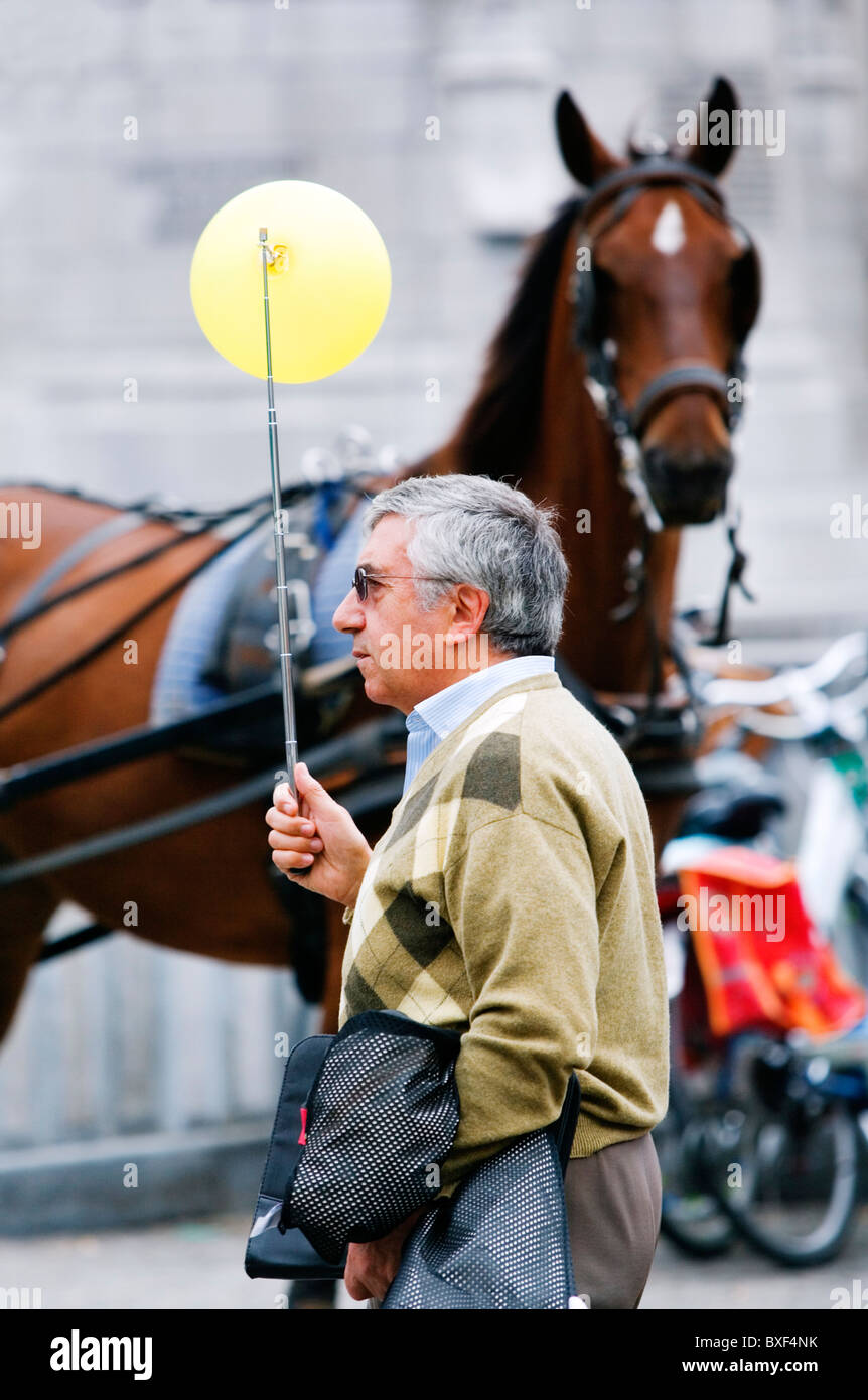 Tour guide with telescopic pointer and yellow balloon, Bruges, Belgium ...