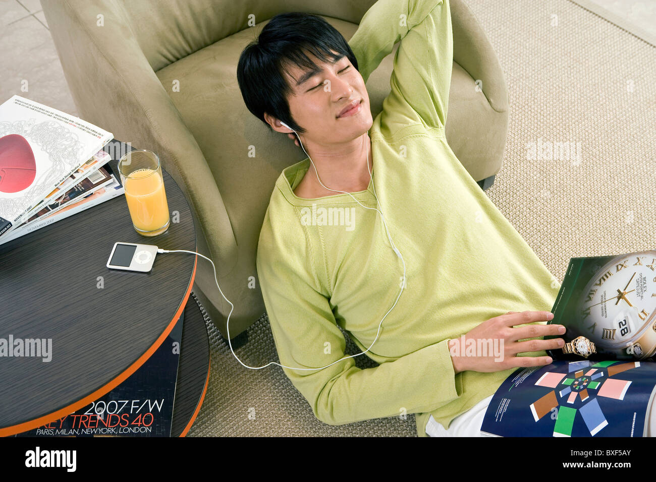 A young man reading a magazine with music high angle Stock Photo - Alamy