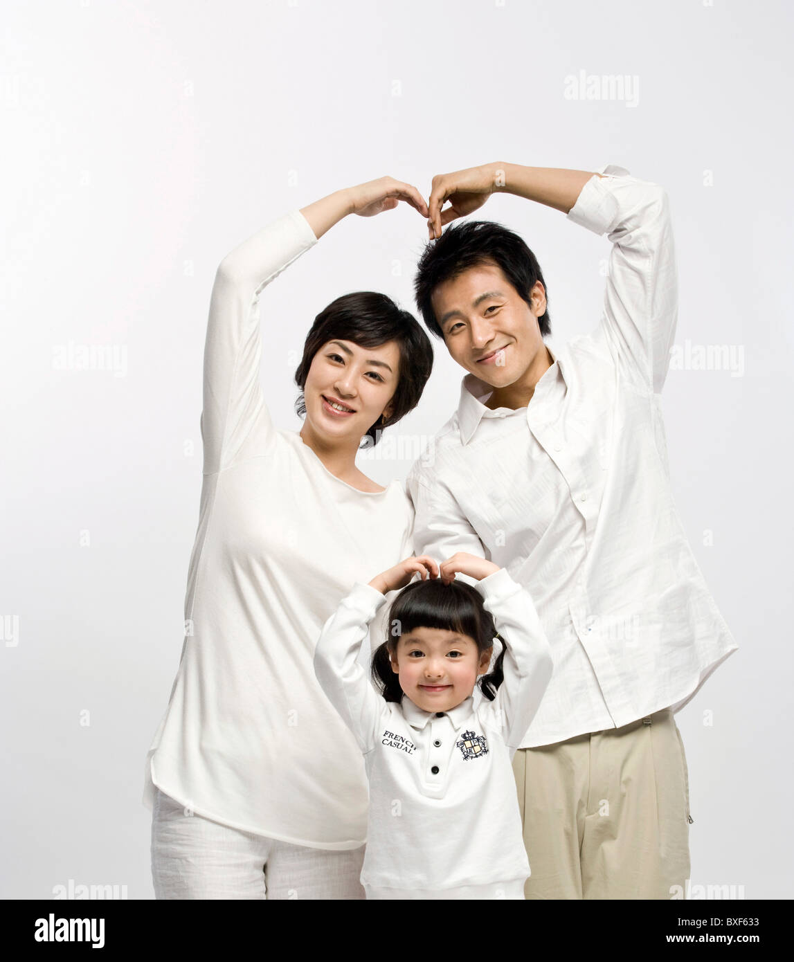 Mom daughter forming heart hands hi-res stock photography and images ...