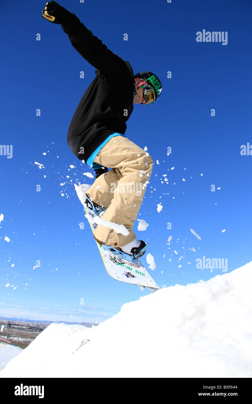 Snowboarding male in mid air on a clear blue sky day Stock Photo - Alamy