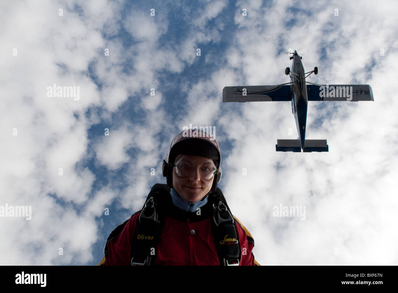 Skydiver girl is practise the head down position and flying free over ...