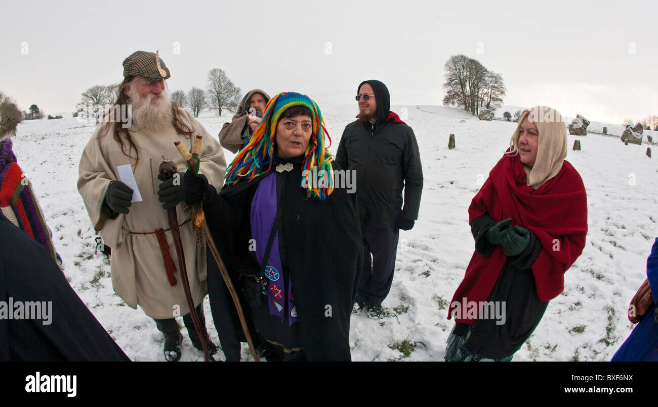 Druids celebrating the Winter Solstice in the snow at Avebury stone ...