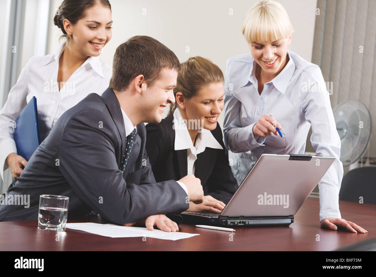 Business woman demonstrating correct way of analysis to three co ...