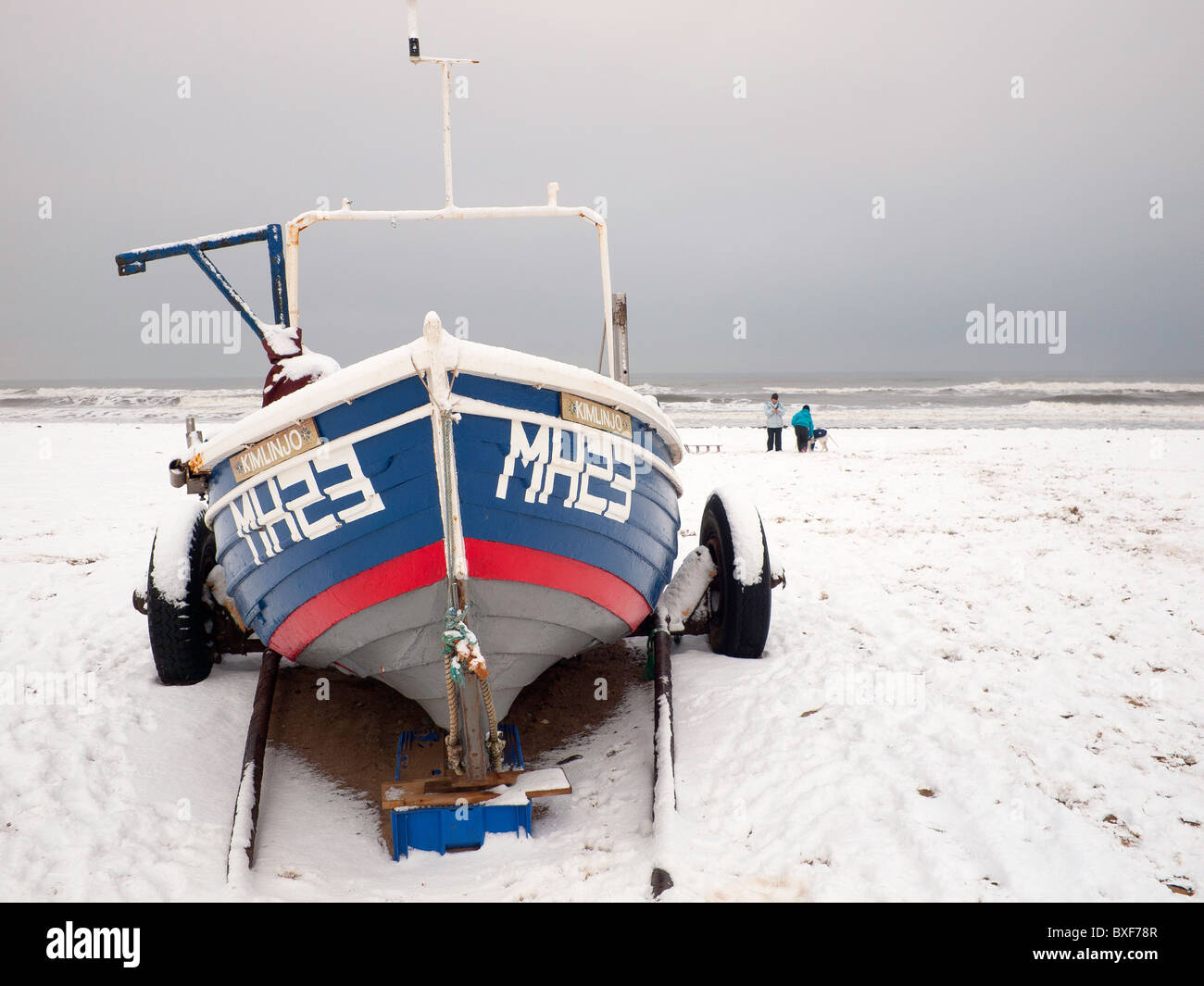 Fishing boat on a snow covered beach at Marske by the Sea Cleveland UK ...