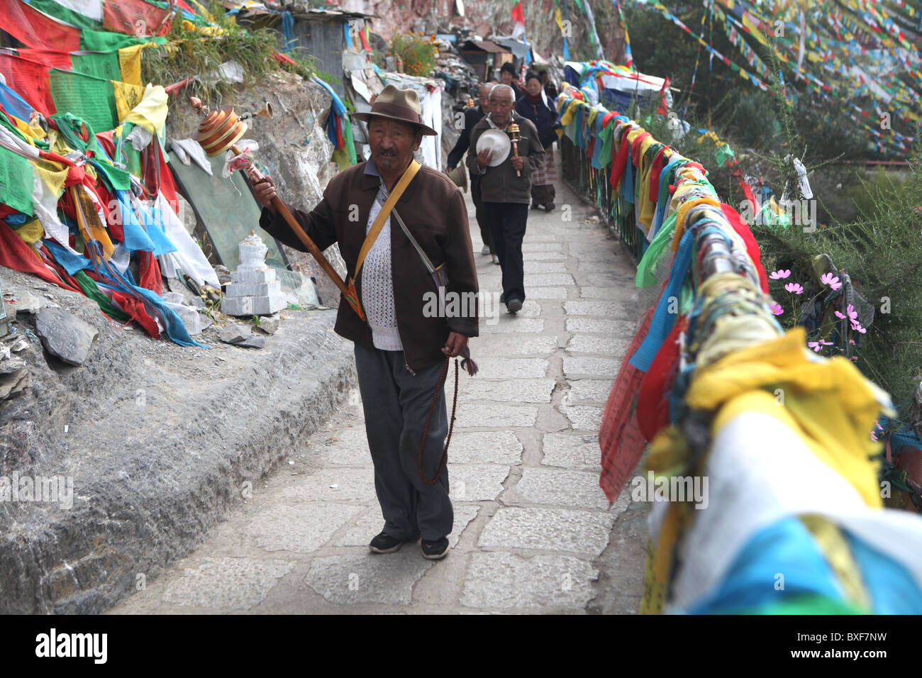 Pilgrims walking the outer pilgrim path or Lingkhor around Iron ...