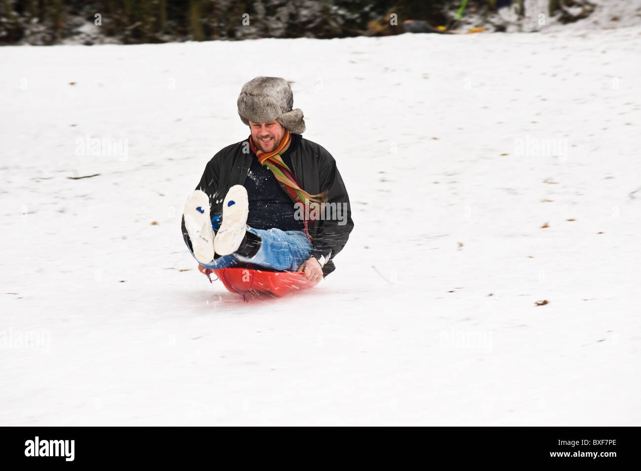 A man on a toboggan Stock Photo - Alamy