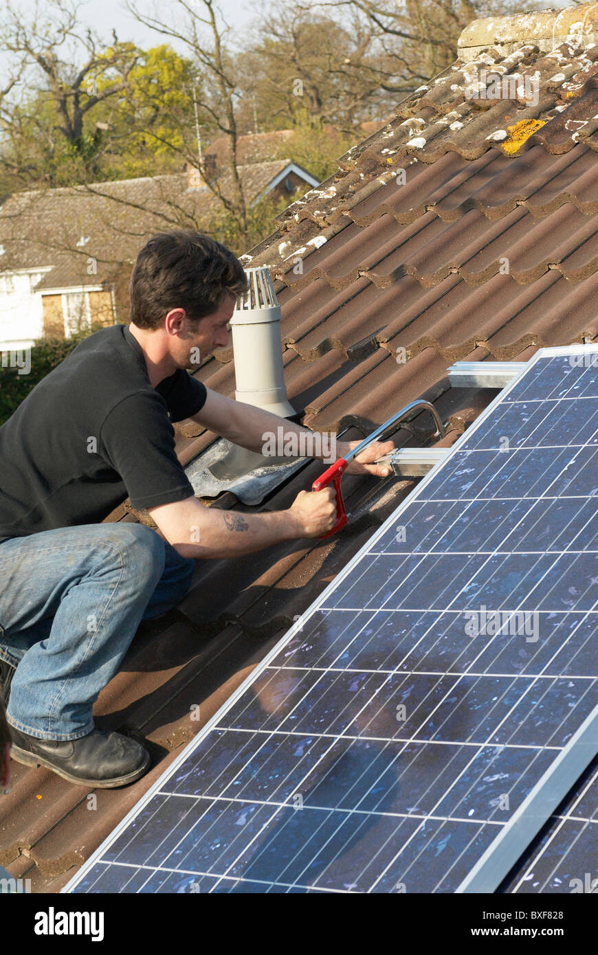 Solar panel man fitting on roof hi-res stock photography and images - Alamy