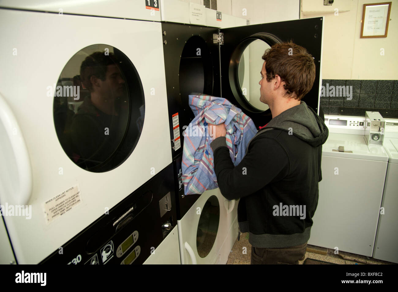 20-30 year old white caucasian male man washing his clothes in a ...