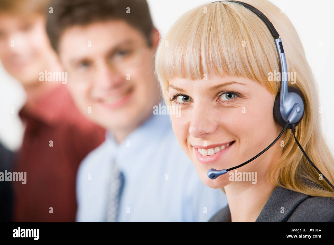 Portrait of friendly smiling telephone operator on the background of ...