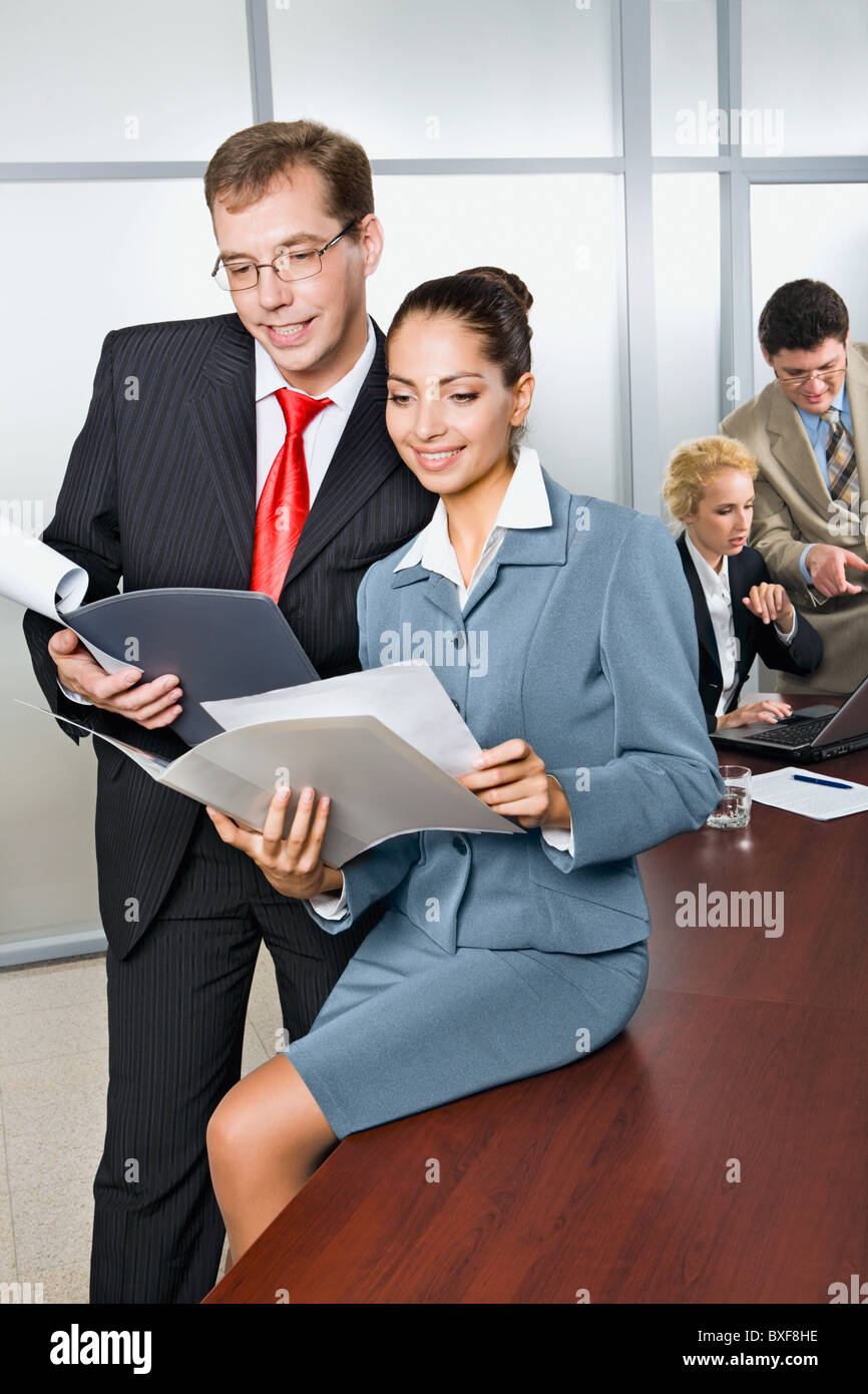 Two business people are looking in the documents Stock Photo - Alamy