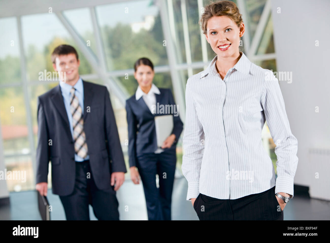 Successful woman putting her hands into the pocket on the background of ...