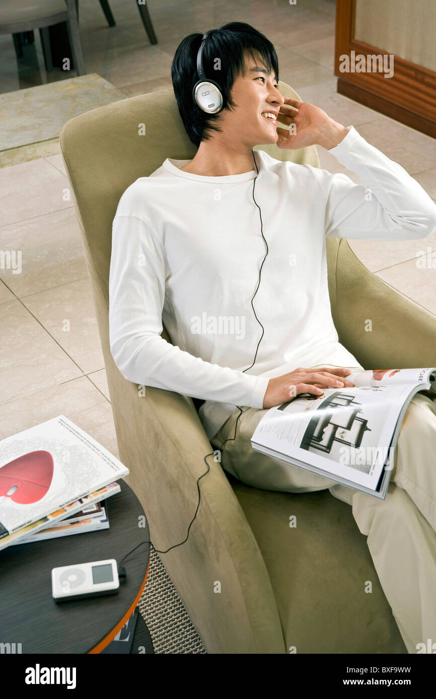 A young man reading a magazine with music Stock Photo - Alamy