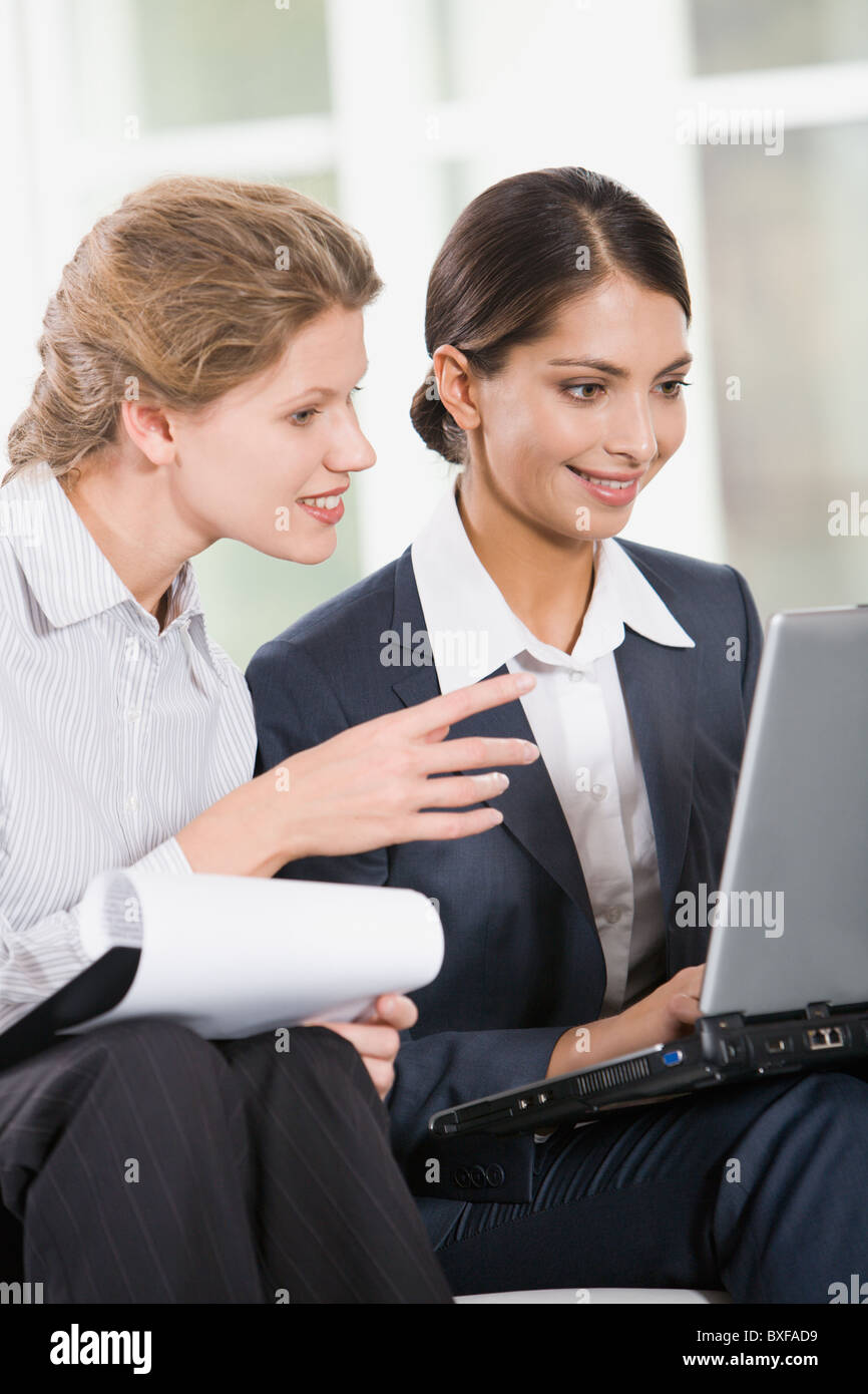 Portrait of two business women looking at the monitor of laptop Stock ...