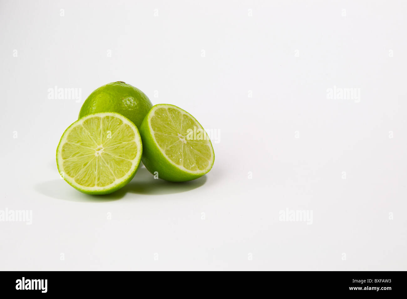 Sliced lime fruit on white background Stock Photo - Alamy