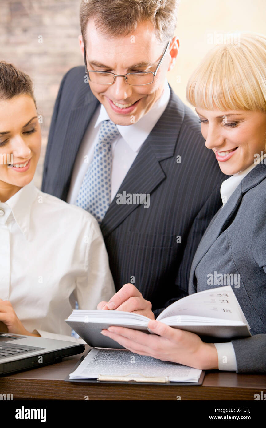 Portrait of three confident white collar office planning their work ...
