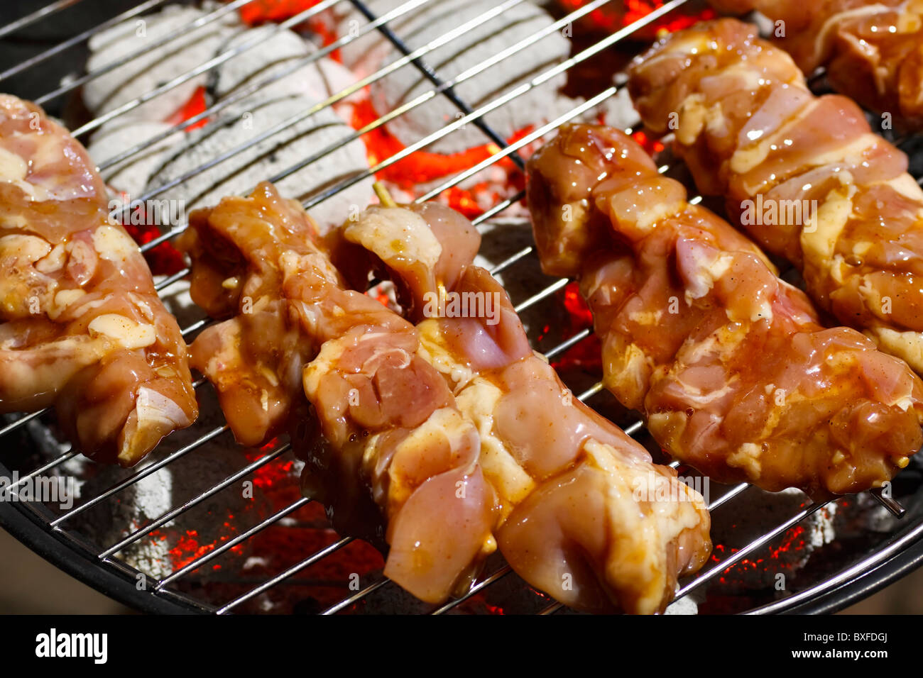 Juicy chicken shish kebabs on a charcoal barbecue grill Stock Photo - Alamy