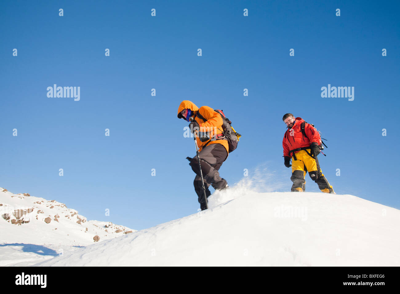 Climbers being blasted by spindrift during high winds moving snow above ...